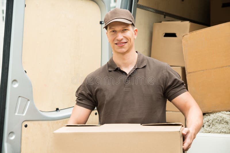 Delivery Man Holding Box stock image. Image of occupation - 56539377