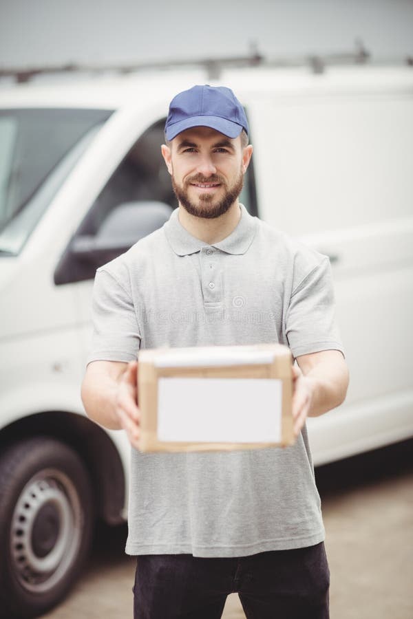 Delivery Man Holding Package Stock Photo - Image of shipping, cardboard ...