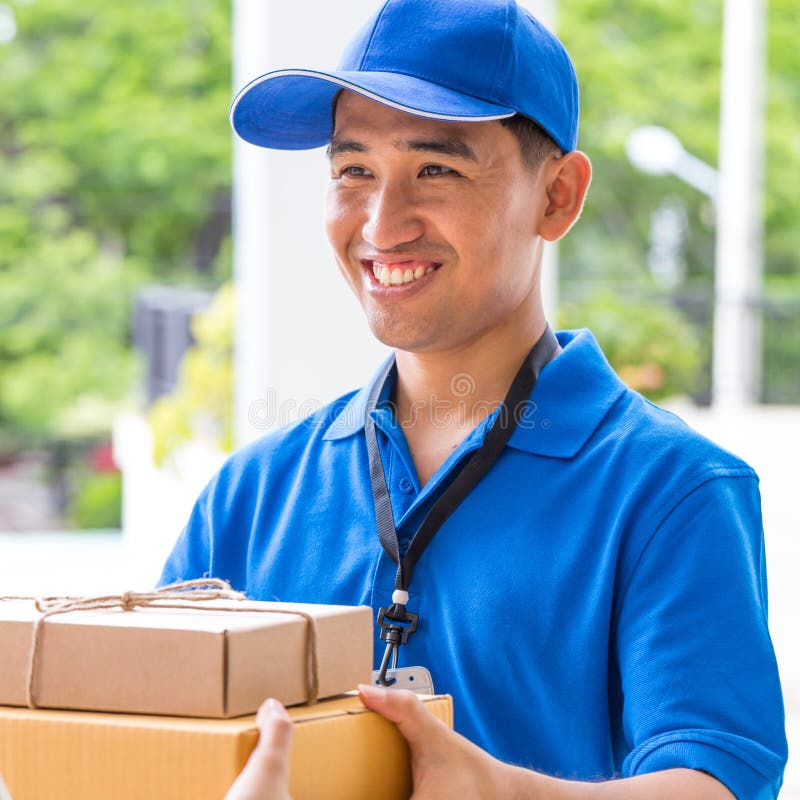 Delivery Man Holding a Parcel Box Stock Photo - Image of smile, happy ...