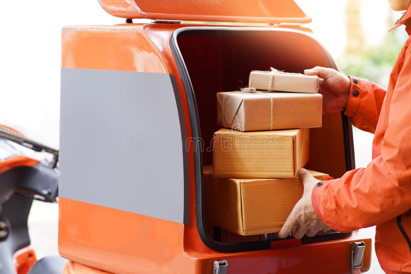Delivery Man Holding Parcel Box from Motorcycle Tail Box To Customer ...