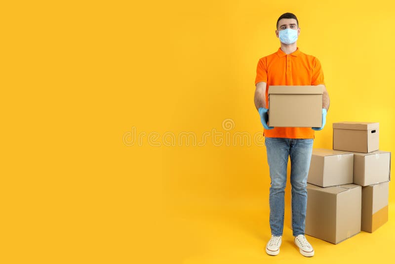 Delivery Man Holds Box on Yellow Background with Boxes Stock Image ...