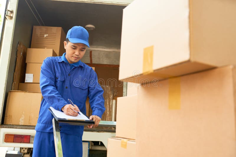 Delivery man loading truck stock photo. Image of service - 138130364
