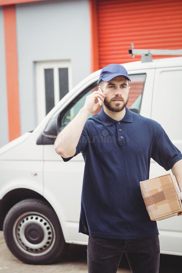 Delivery Man Making a Phone Call Stock Photo - Image of delivery ...