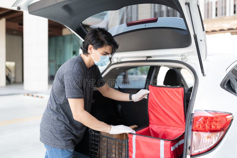 Delivery Man Opening Backpack in Car Trunk Stock Photo - Image of ...