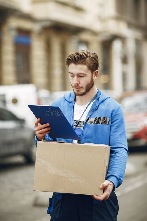 Delivery Man with Package Outdoors Stock Image - Image of ...