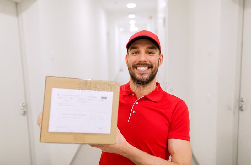 Delivery Man with Parcel Box in Corridor Stock Image - Image of package ...