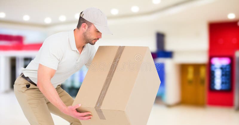 Delivery Man Picking Up Box Against Blurry Shopping Centre Stock Photo ...