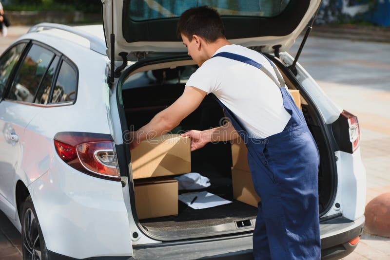 Delivery Man Picking Up Box from Car Stock Image - Image of mail, face ...
