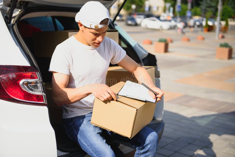 Delivery Man Picking Up Box from Car Stock Photo - Image of freight ...