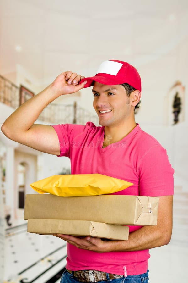 Delivery Man in Pink Uniform Holding Boxes and Documents. Stock Photo ...