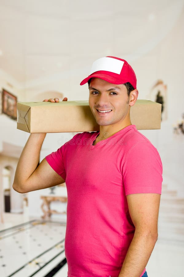 Delivery Man in Pink Uniform Holding One Box Over His Shoulders Stock ...