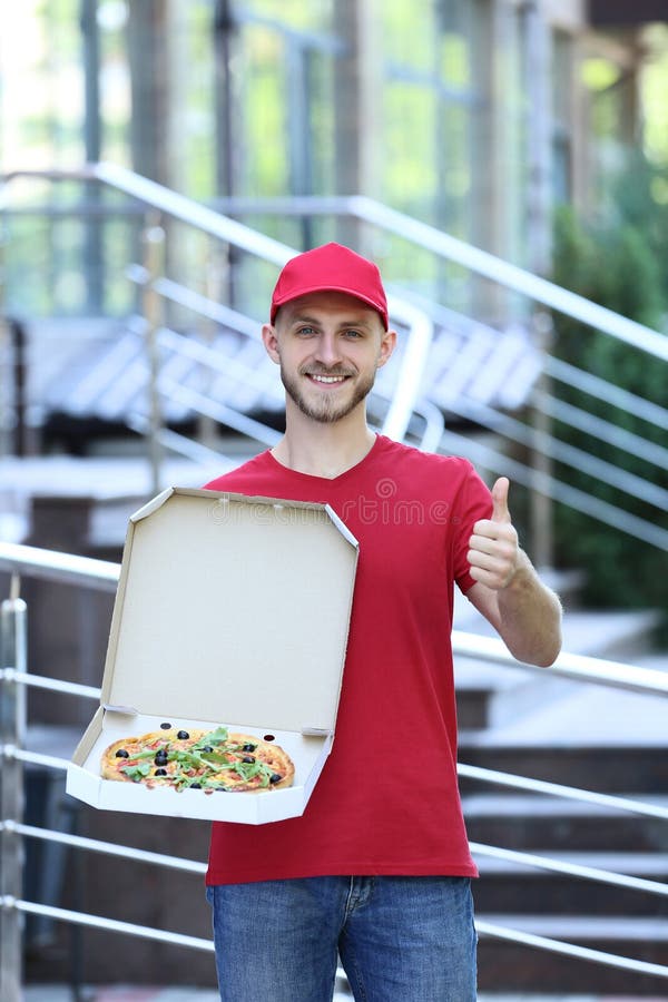 Delivery man with pizza stock image. Image of italian - 125953573