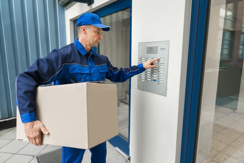 Delivery Man Pressing Button of Intercom To Enter Building Stock Image ...