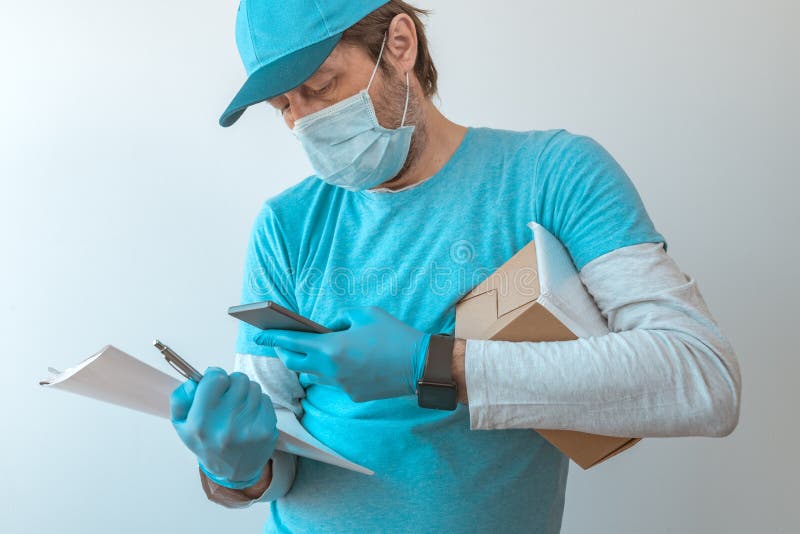 Delivery Man with Protective Clothing Using Smartphone Stock Photo ...