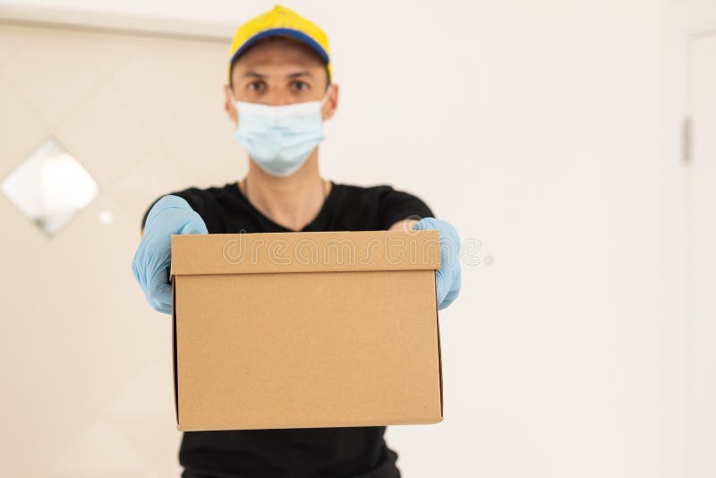 Delivery Man in Protective Gloves and a Mask Stock Photo - Image of ...