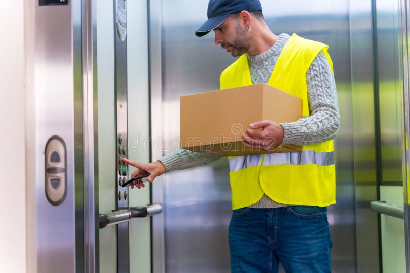 Delivery Man in a Protective Uniform at Online Order Delivery Going Up ...