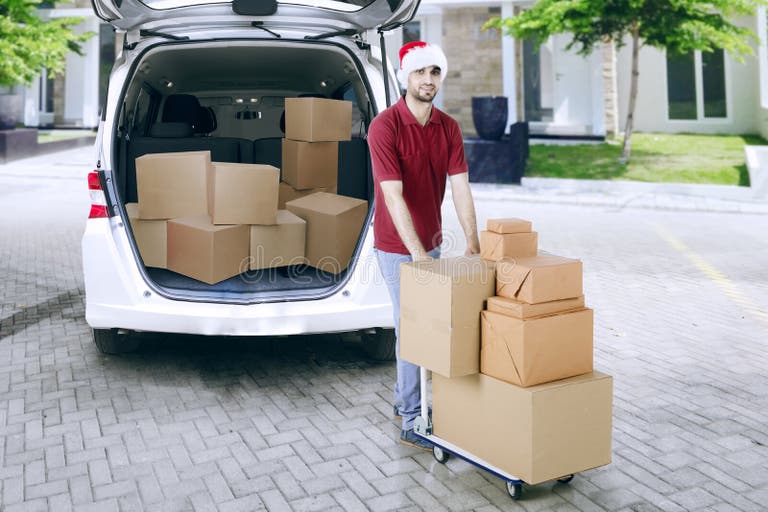 Delivery Man Pushing a Stack of Package Stock Image - Image of ...
