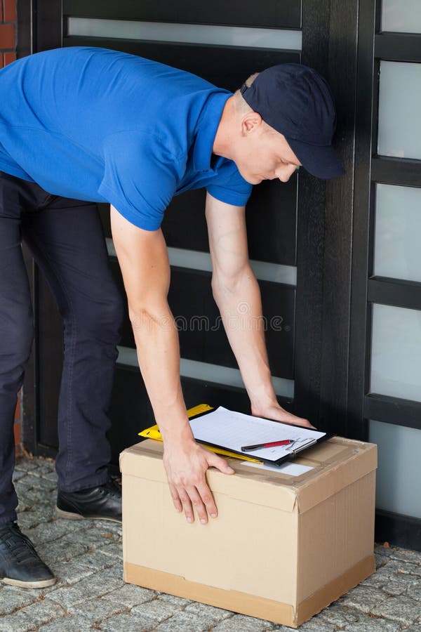 Delivery Man Putting Down Parcel Stock Photo - Image of documents ...