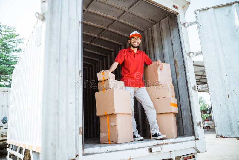 Delivery Man Standing between Several Package Boxes in Container Truck ...
