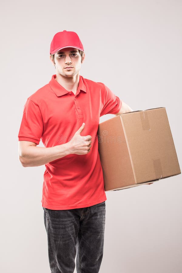 Delivery Man in Red Uniform with Thumbs Up with Box in Hands Isolated ...