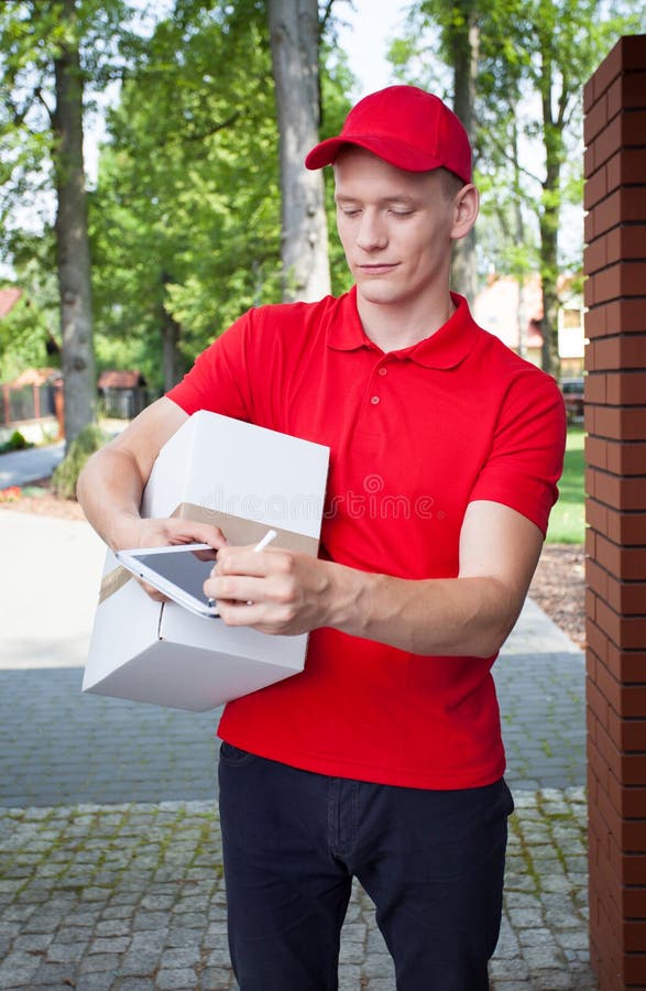 Delivery man with a tablet stock photo. Image of carton - 44966368