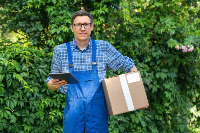 Delivery Man in Uniform with Digital Tablet Stock Photo - Image of ...