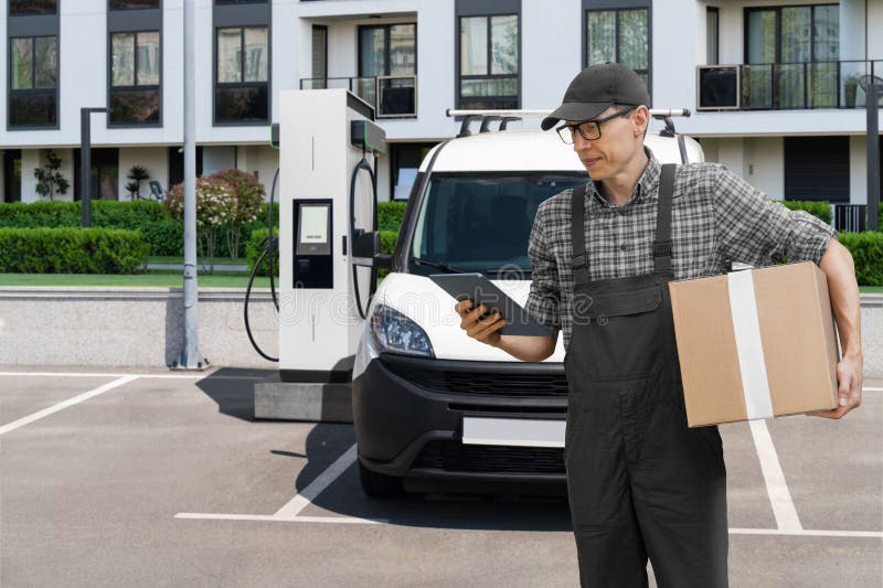 Delivery Man in Uniform with Digital Tablet Next To Electric Van Stock ...