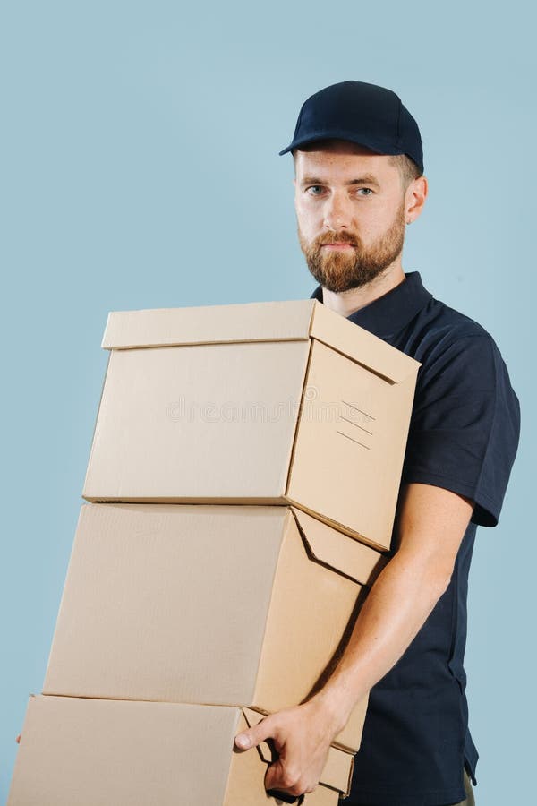 Delivery Man is Checking His Orders List while Standing Next To Stack ...