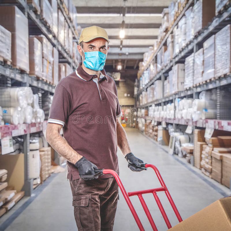 Delivery Man with Uniform and Protective Mask for Covid-19 Inside a ...