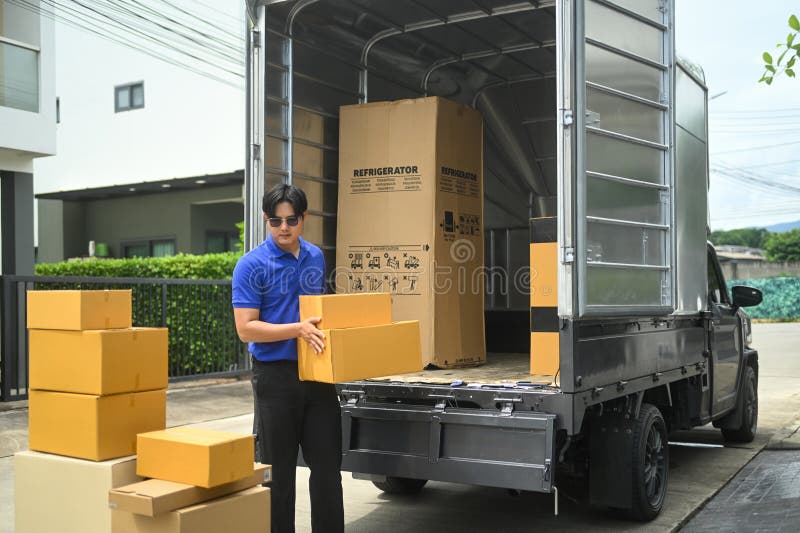 Delivery Man Unloading Packages from the Back of a Truck ...