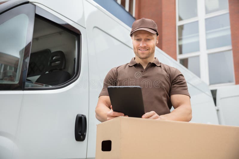Delivery Man Using Digital Tablet by Truck Against Sky Stock Image ...