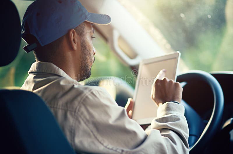 Delivery Man, Van and Checking Tablet for Online Information on ...