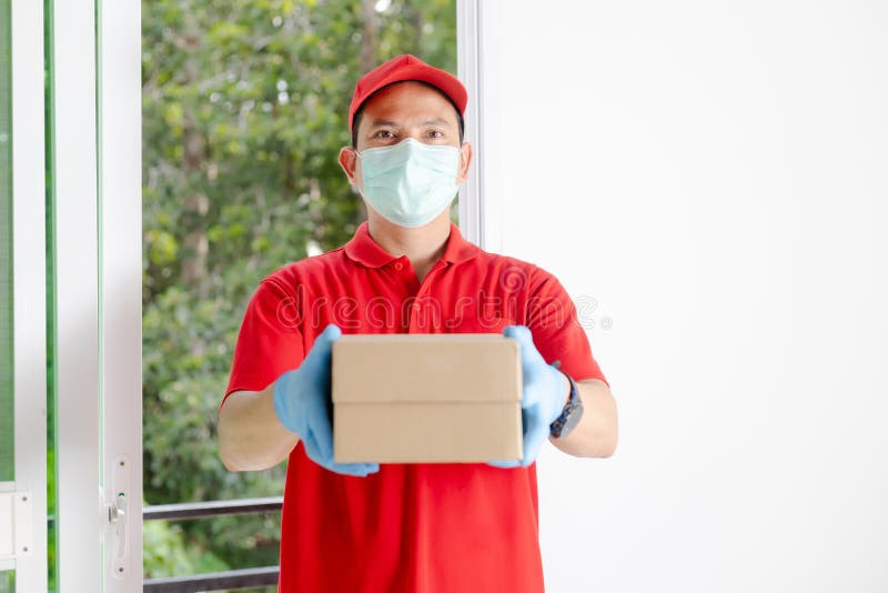 A Delivery Man Wearing a Red Dress Holds a Parcel Box Stock Image ...