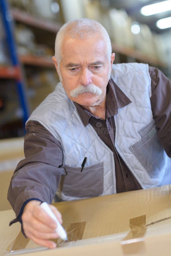 Delivery Man Writing on Cardboard Boxes Stock Image - Image of boxes ...