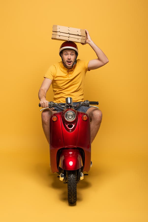 Delivery Man in Yellow Uniform on Scooter Pointing with Finger at Pizza ...