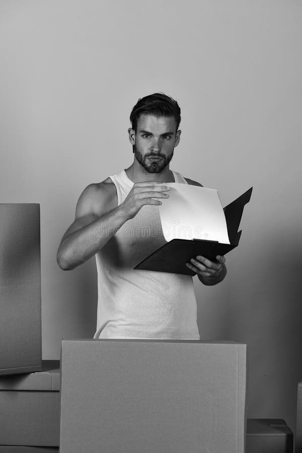 Delivery and Moving in Concept: Macho Checking on Documents Stock Photo ...