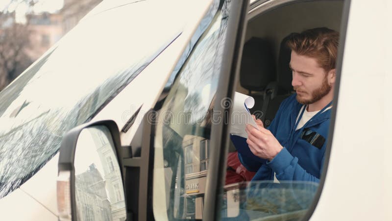 Delivery Driver Checking the Paperwork in His Van Stock Video - Video ...