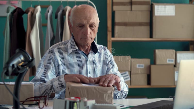Delivery Service, Old Man Working Barcode on Box To Confirm Sending ...