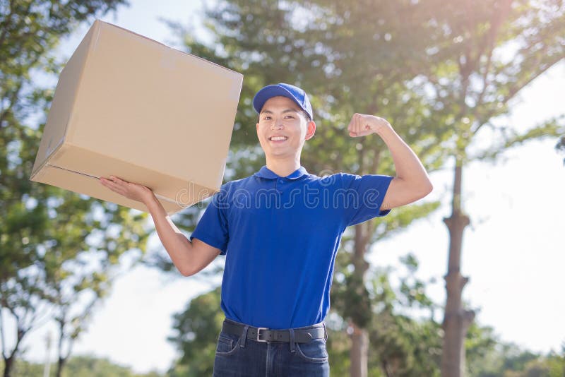 Deliveryman hold heavy box stock photo. Image of asia - 85875528