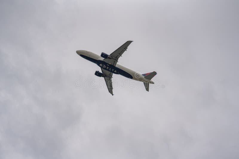 Delta jet flying overhead editorial stock photo. Image of airplane ...