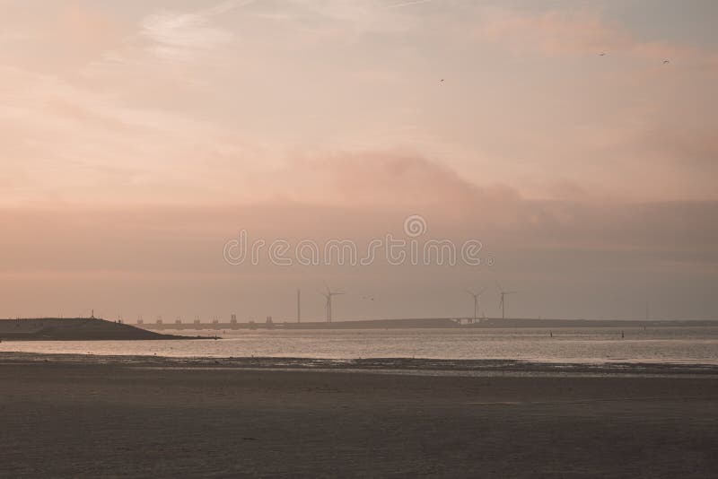 Delta works at sunset stock photo. Image of windmill - 100847826