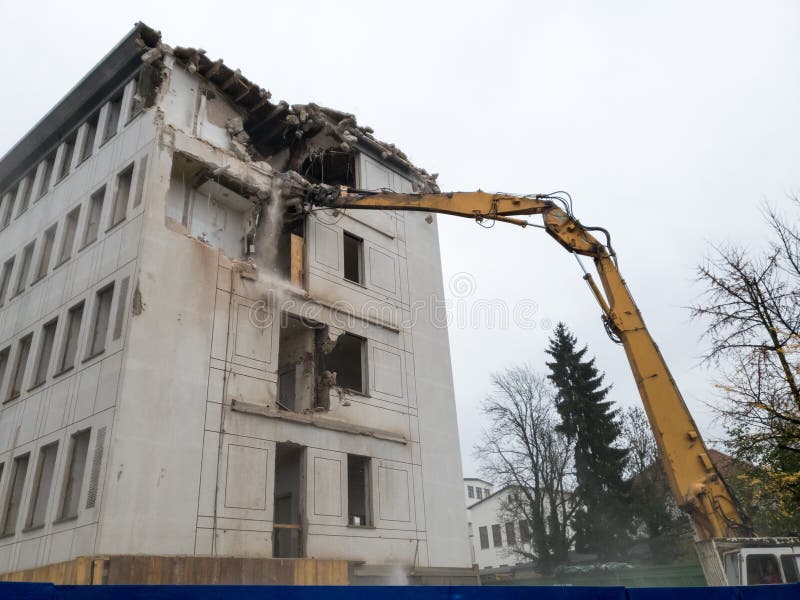 Demolishing a Old Outdated Building with Heavy Machinery. Stock Photo ...