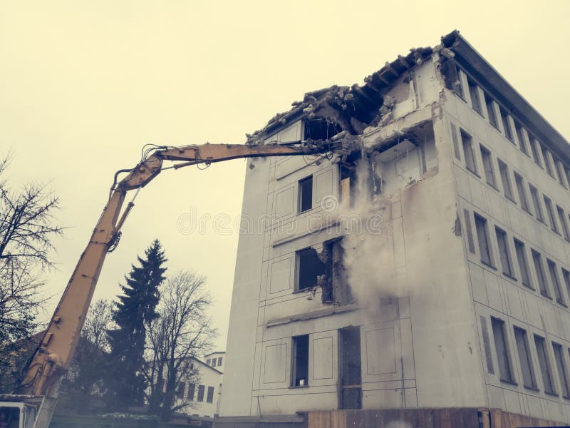 Demolishing a Old Outdated Building with Heavy Machinery. Stock Photo ...