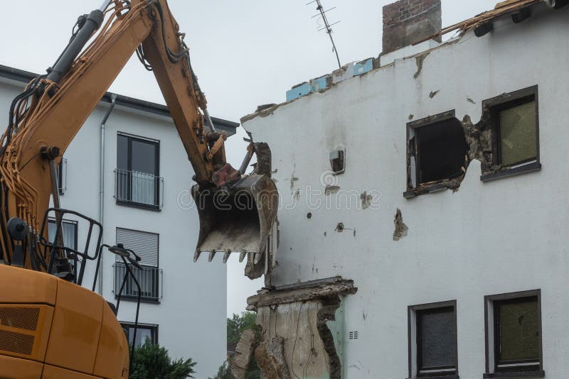 Demolition of a Building. an Excavator Breaks an Old House Stock Image ...