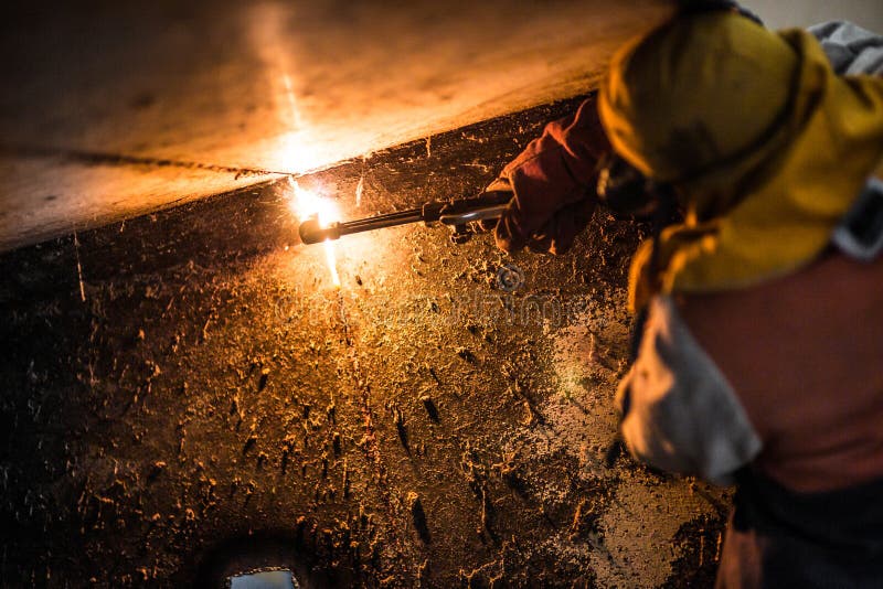 Demolition Construction Worker Using a Flame Torch To Cut Up Heavy ...