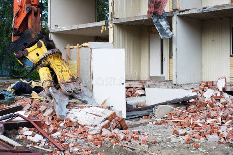 Demolition Work, Excavator Crushing Brick Wall Stock Photo - Image of ...