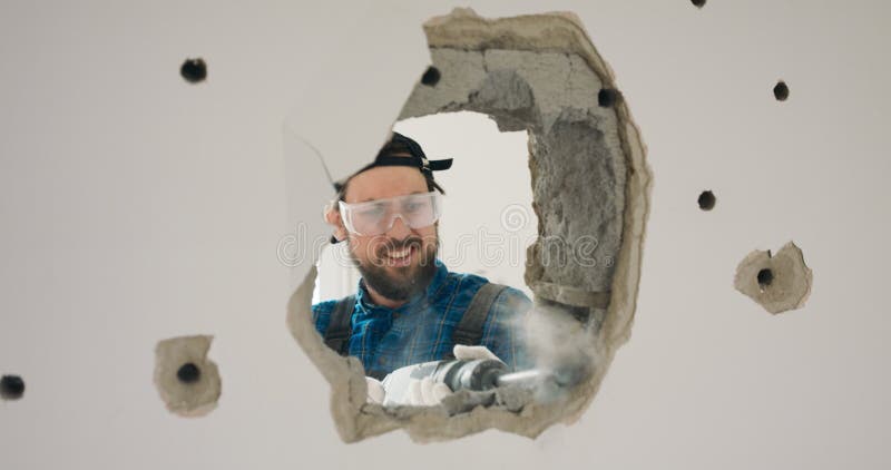 Detail View of a Construction Worker Using a Handheld Demolition Hammer ...