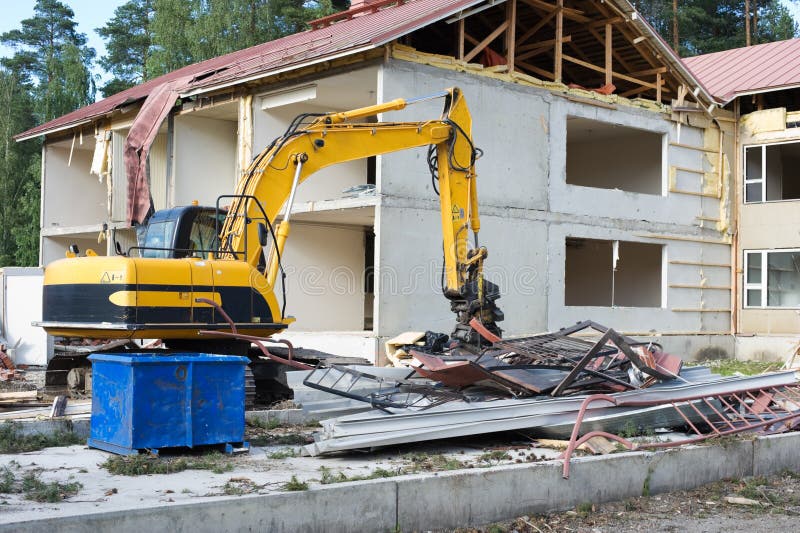 Excavator and Scrap Metal in Front of Partially Demolished House. Stock ...