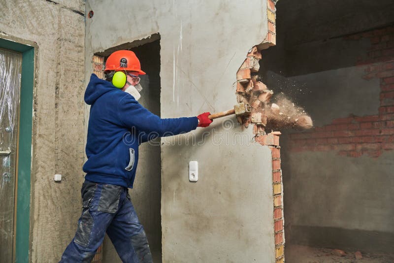 Demolition Work and Rearrangement. Worker with Sledgehammer Destroying ...