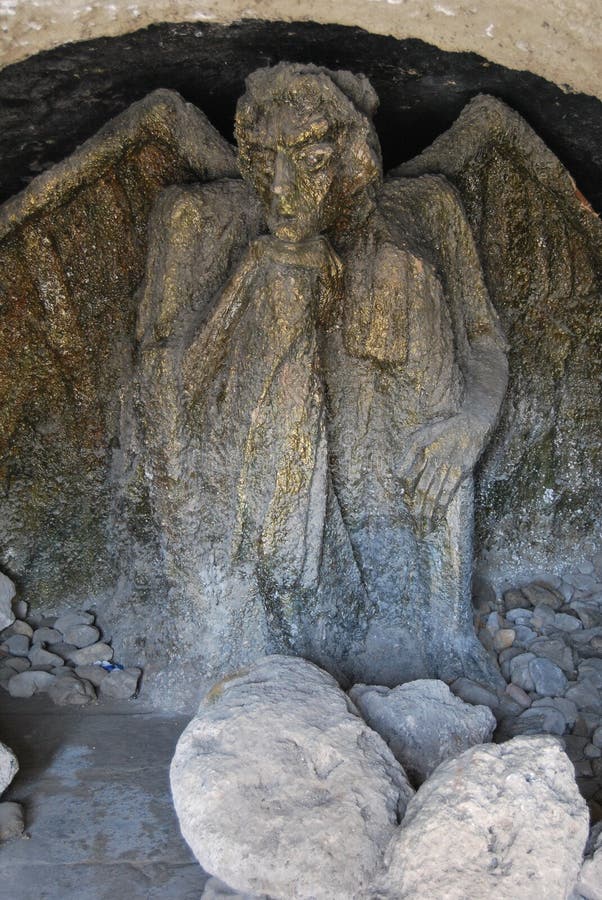 Demon statue in a cave stock photo. Image of formation - 261245948
